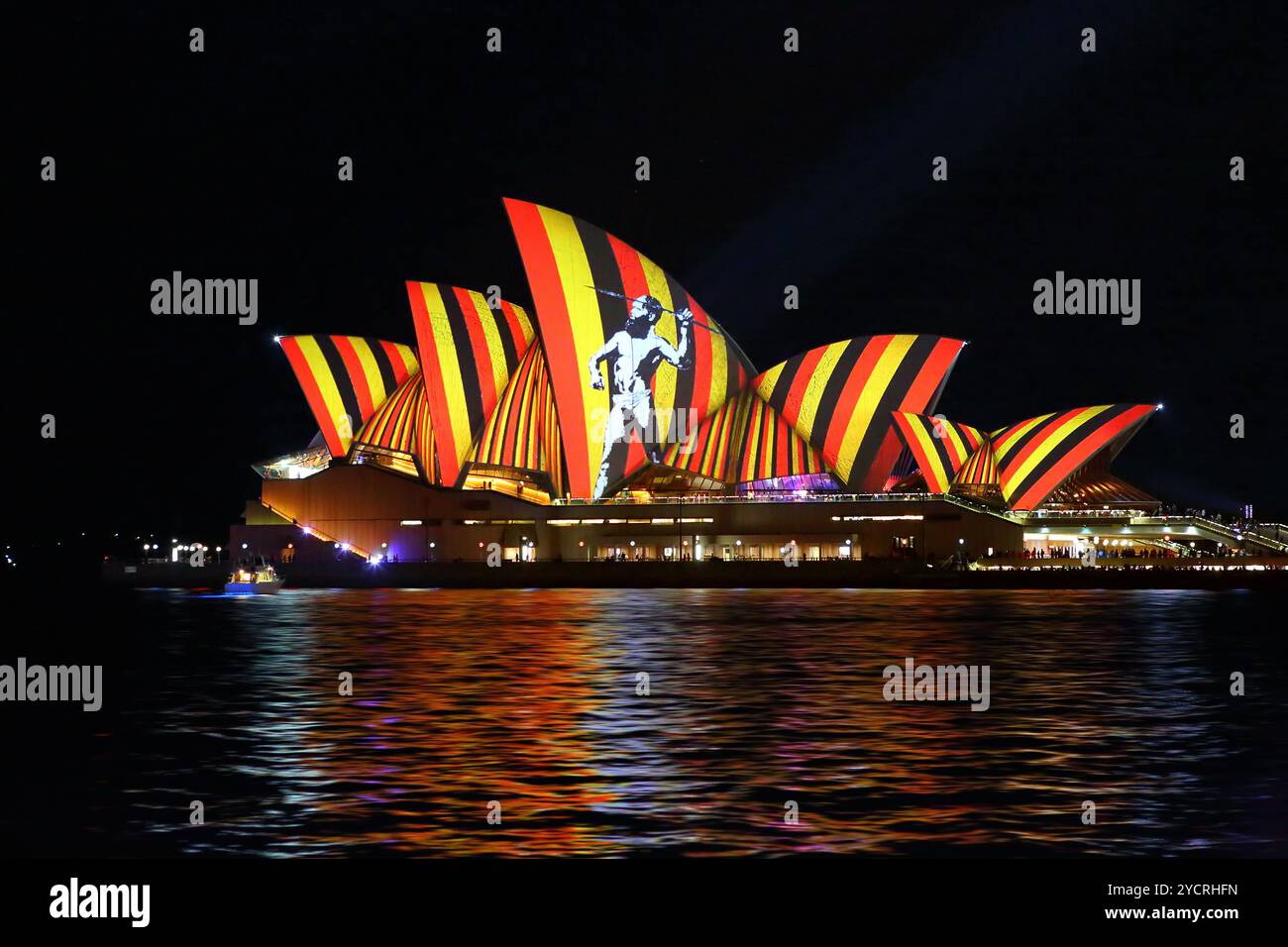 Aboriginal hunter on Sydney Opera House Vivid Sydney Stock Photo - Alamy