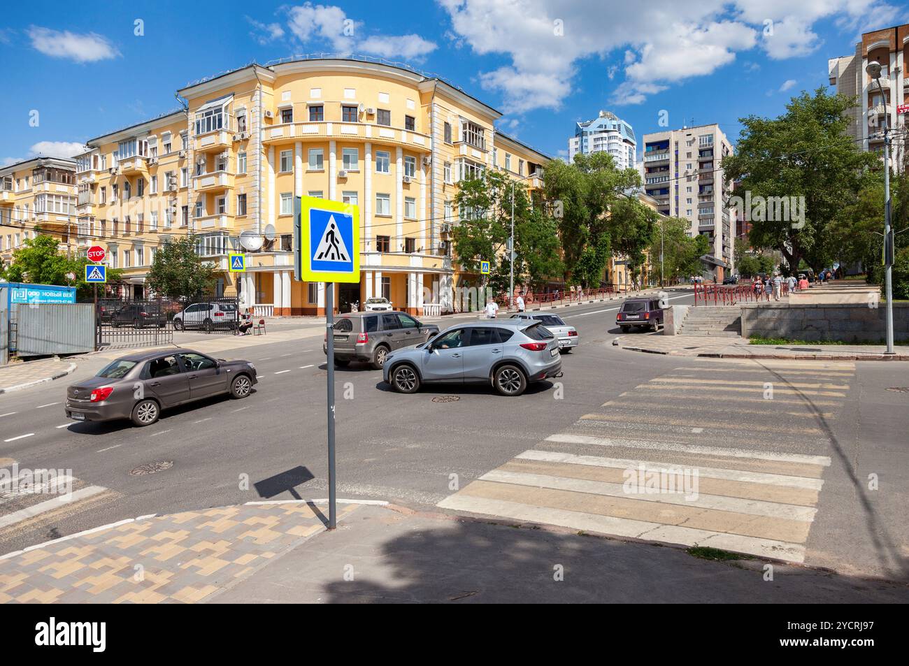 Pedestrian crossing with traffic signs and vehicles on the city street ...