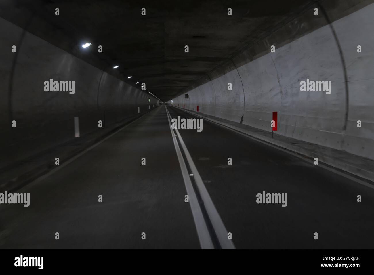 A view of a tunnel and highway leading through a mountain in the ...