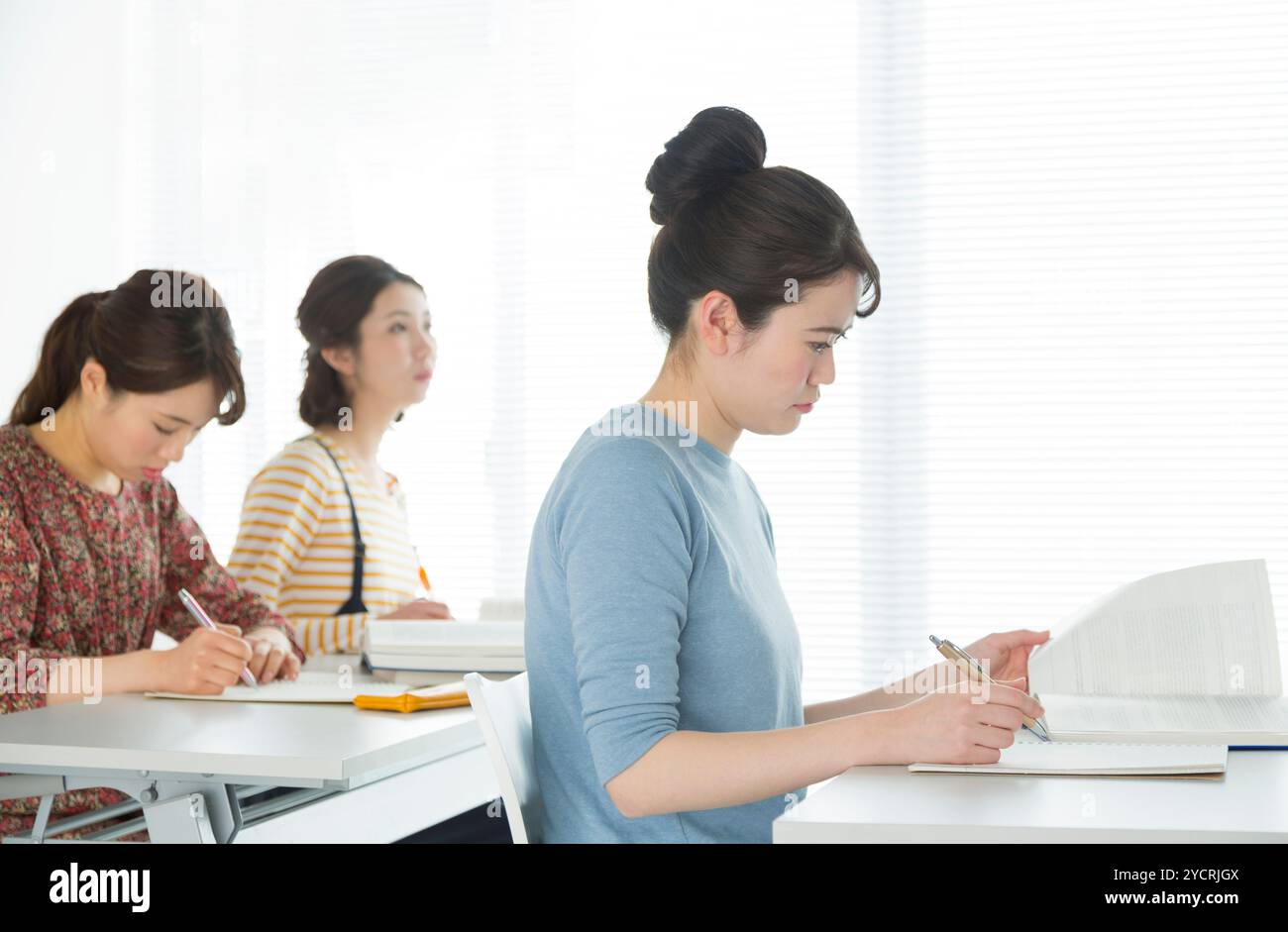 Female university students taking classes Stock Photo - Alamy