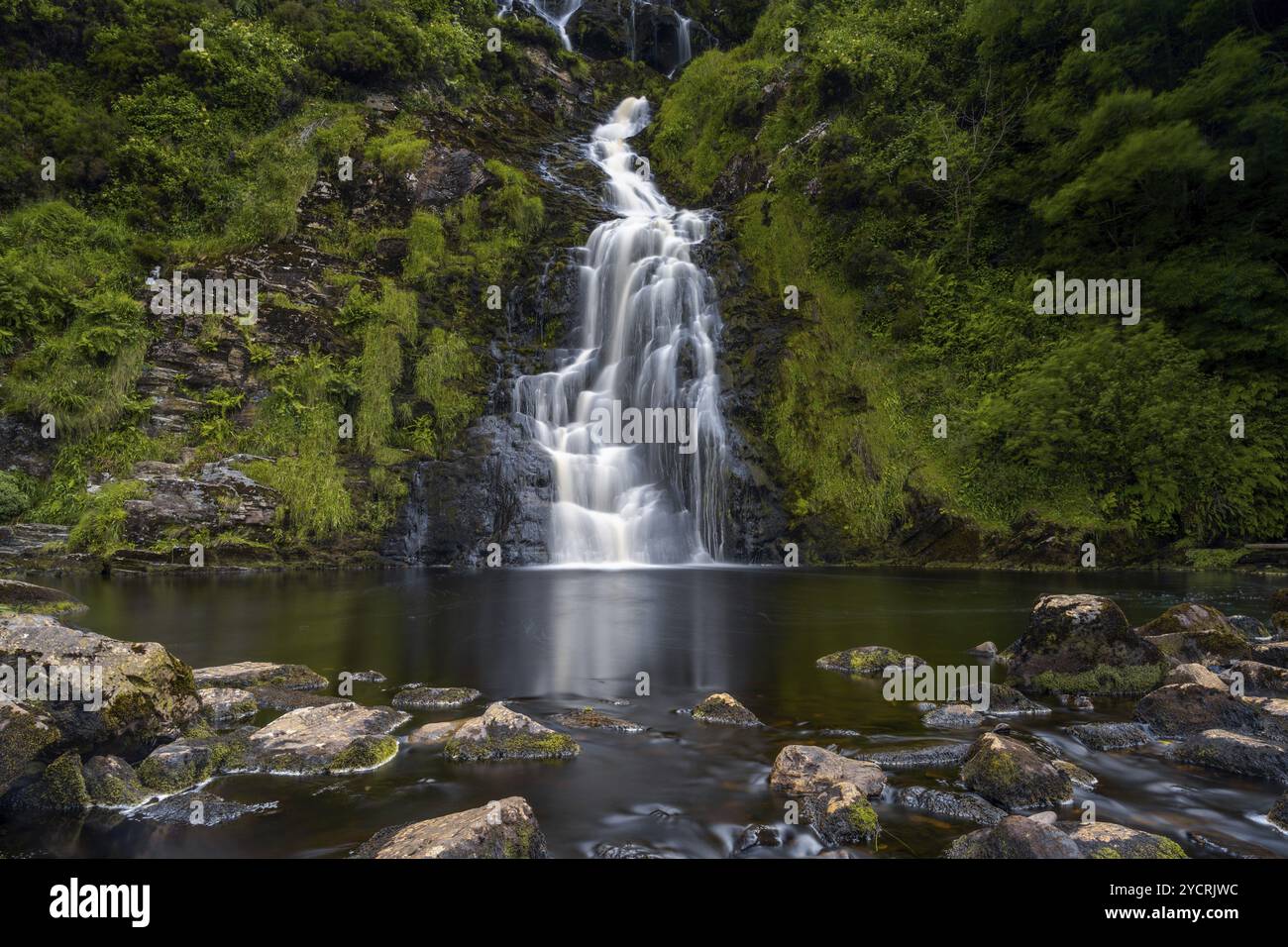 A horizontal view of the picturesque Assaranca Waterfall on the coast ...