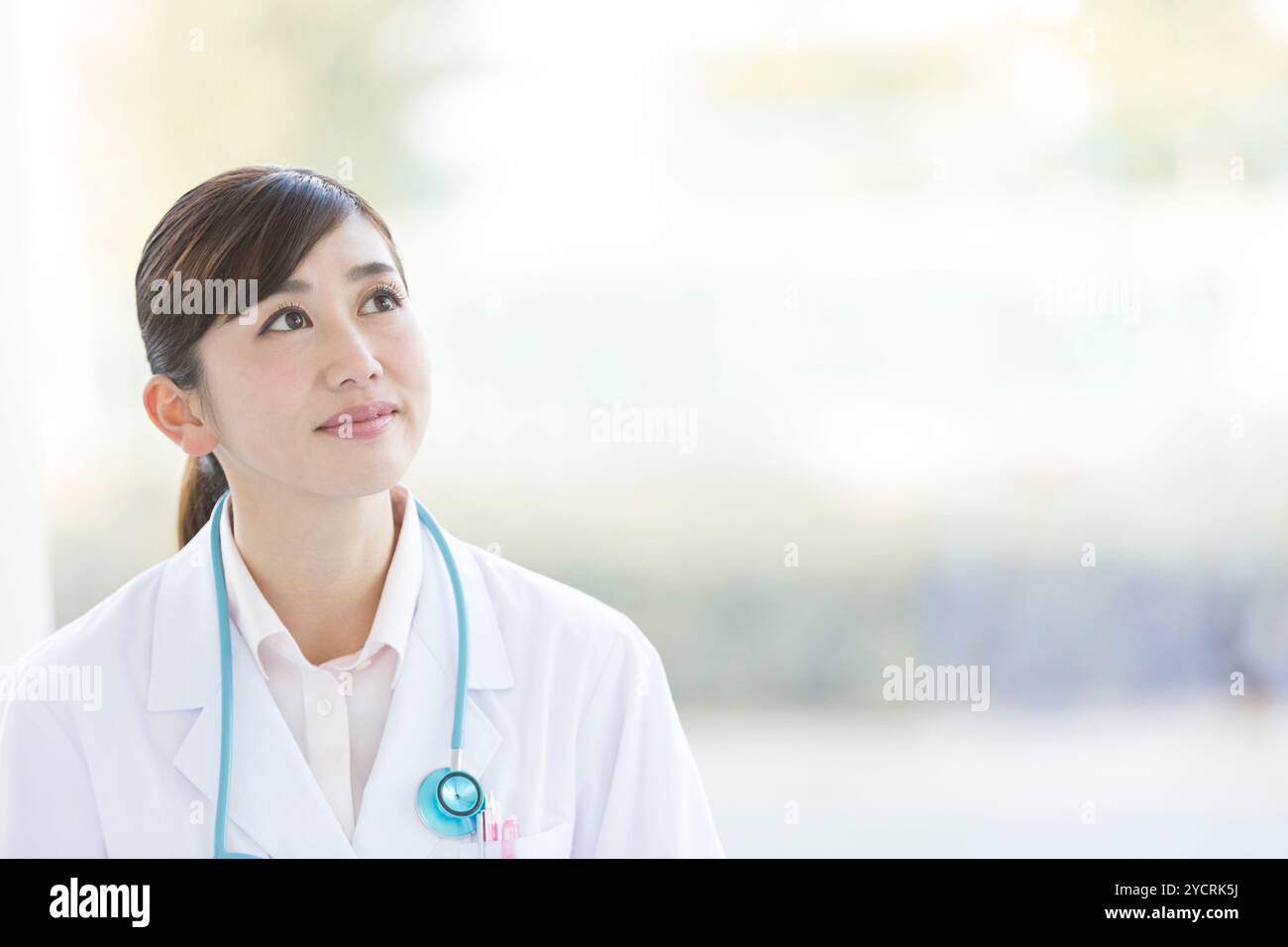 Female doctor looking in the distance Stock Photo - Alamy