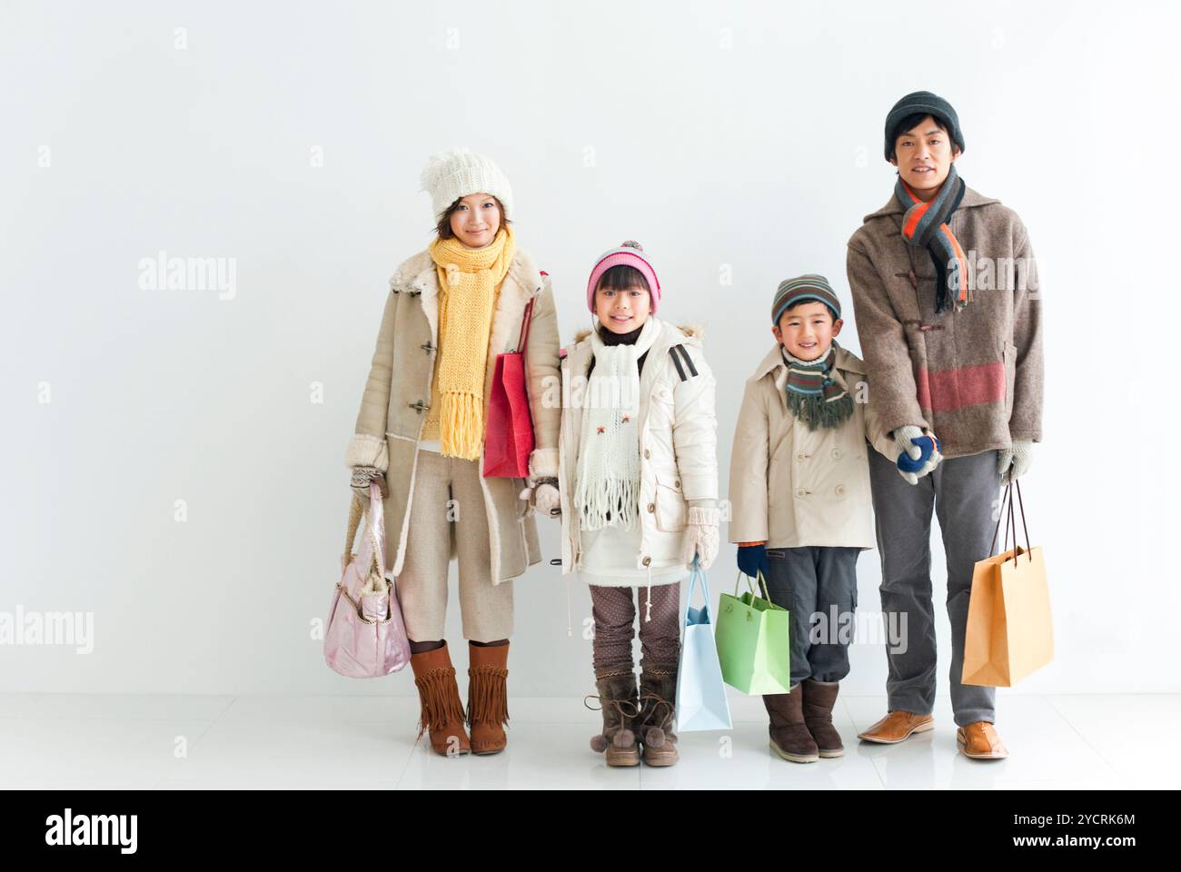 Family standing in line holding hands Stock Photo - Alamy