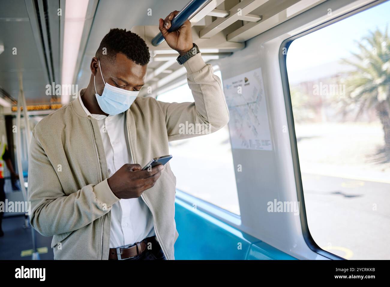 Train, phone and business black man with mask for public transport ...