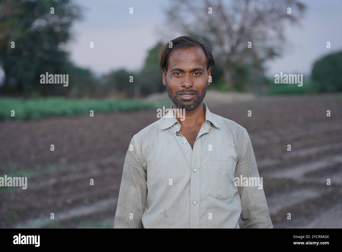 Indian farmer, young, laboring on the field Stock Photo - Alamy