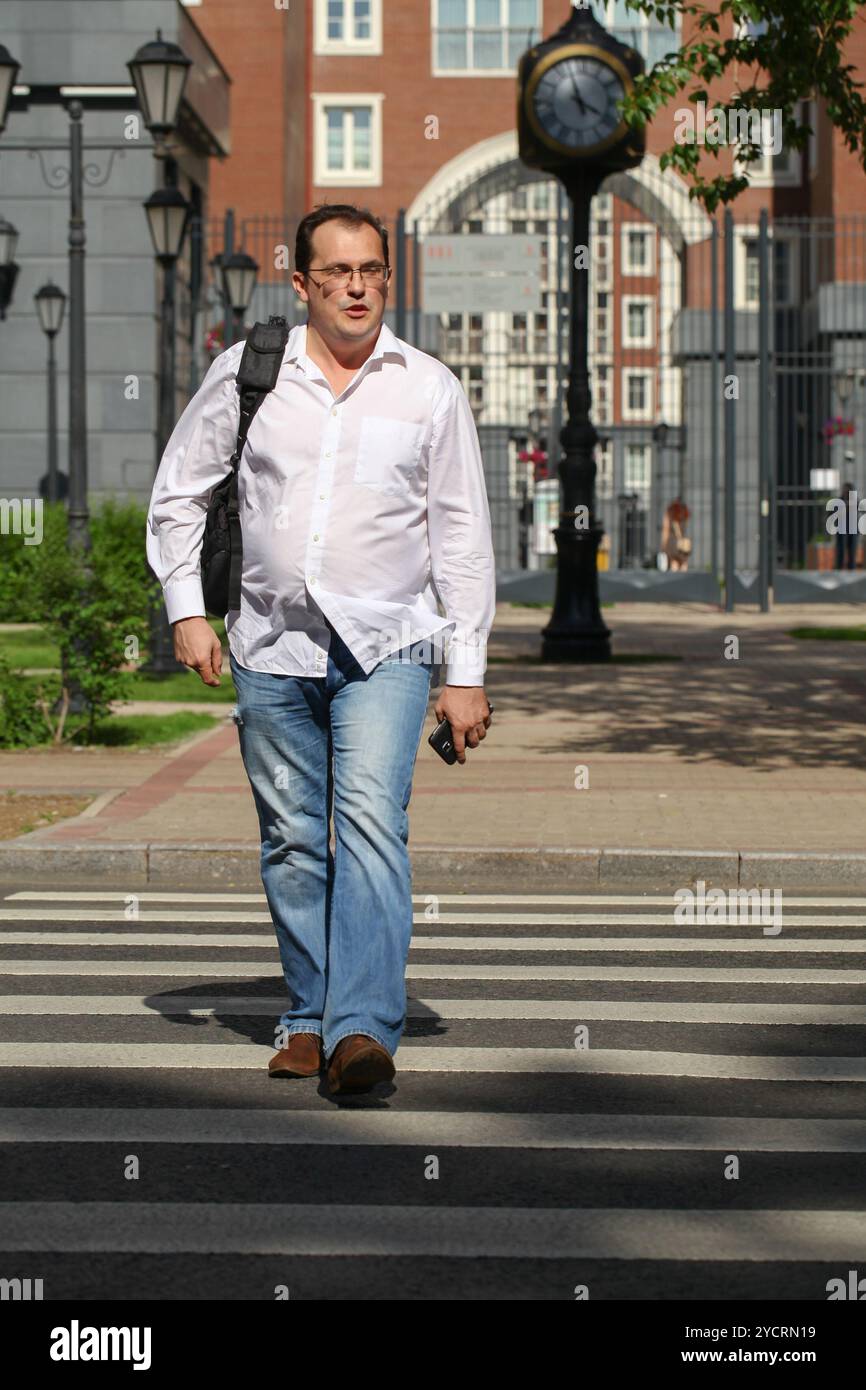 Middle aged entrepreneur walking outside hi-res stock photography and ...