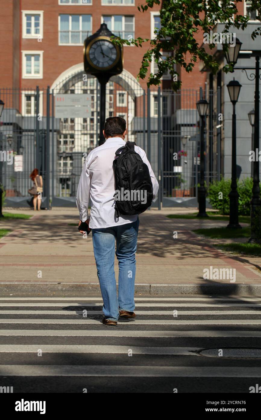 Man crossing the road Stock Photo - Alamy