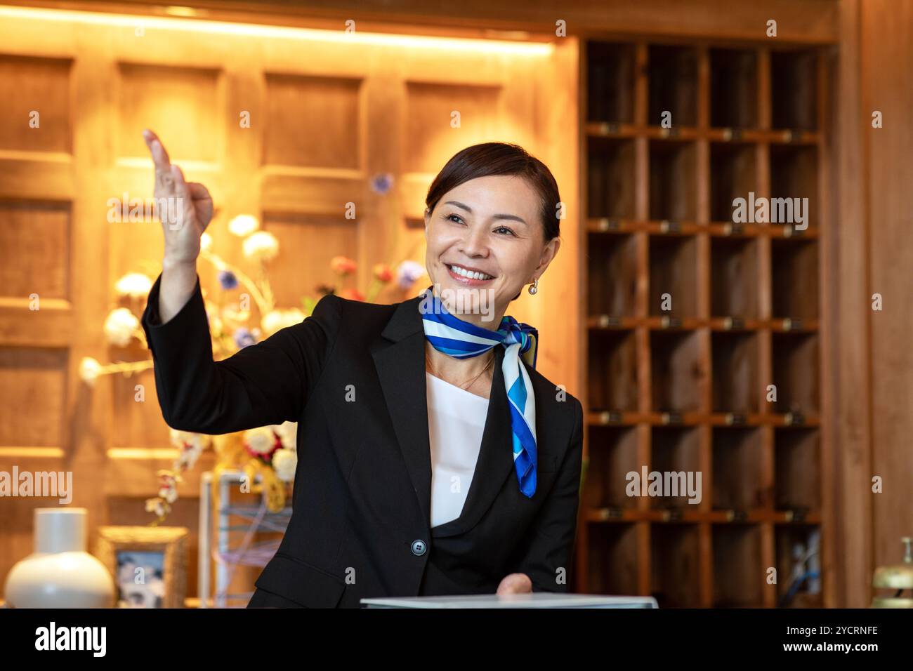 Concierge woman standing at the front desk Stock Photo - Alamy
