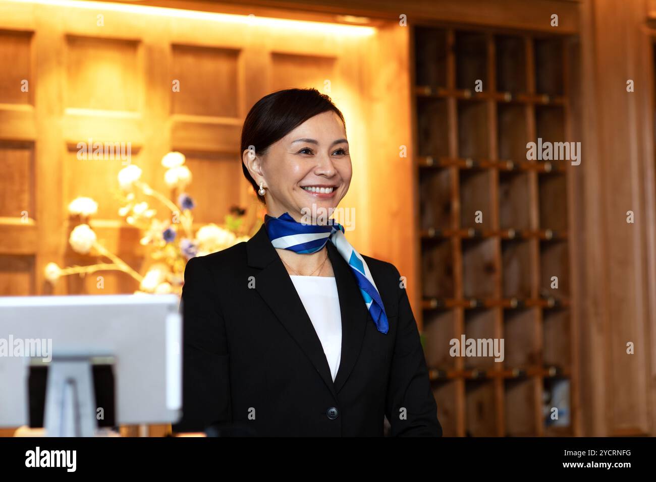 Concierge woman standing at the front desk Stock Photo - Alamy