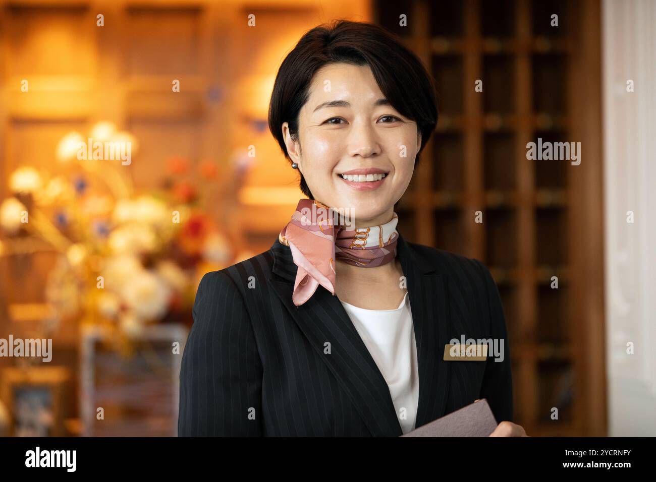 Concierge woman standing at the front desk Stock Photo - Alamy
