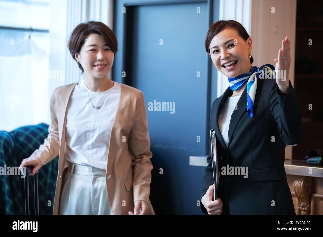 Woman at front desk serving customers Stock Photo - Alamy