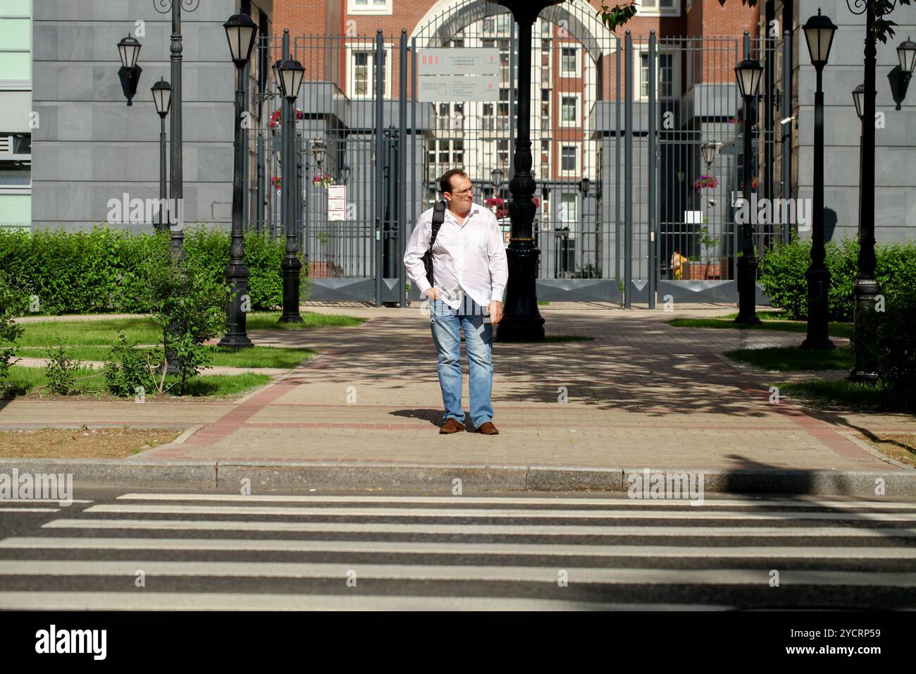 Man crossing the road Stock Photo - Alamy