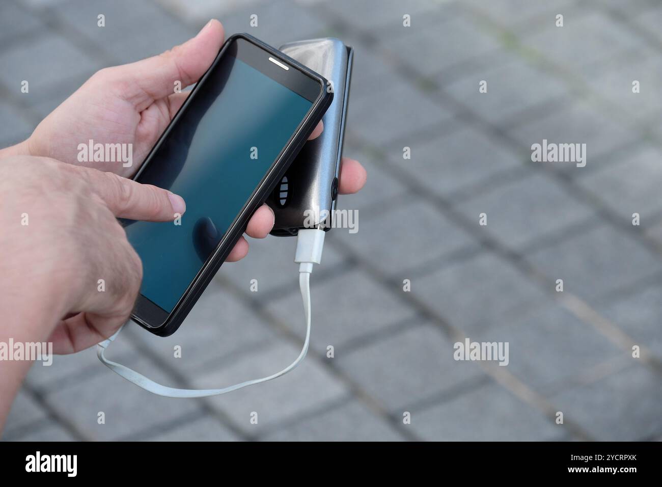 Man charging smartphone Stock Photo - Alamy