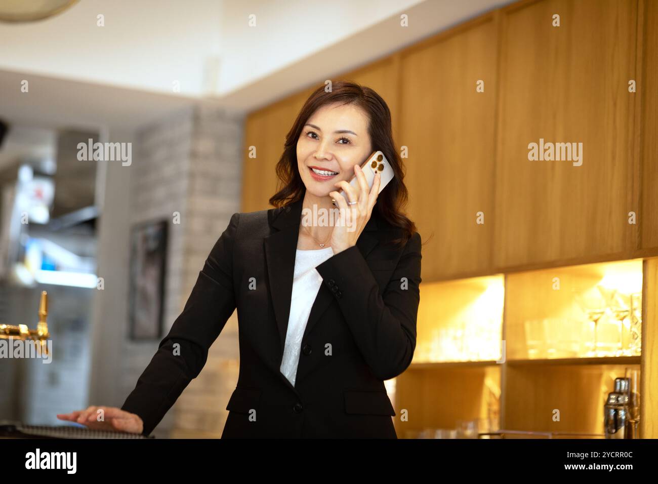 Cafe owner making a phone call Stock Photo - Alamy