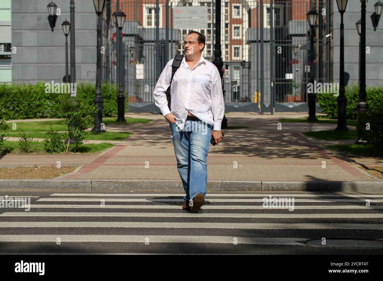 Man crossing the road Stock Photo - Alamy