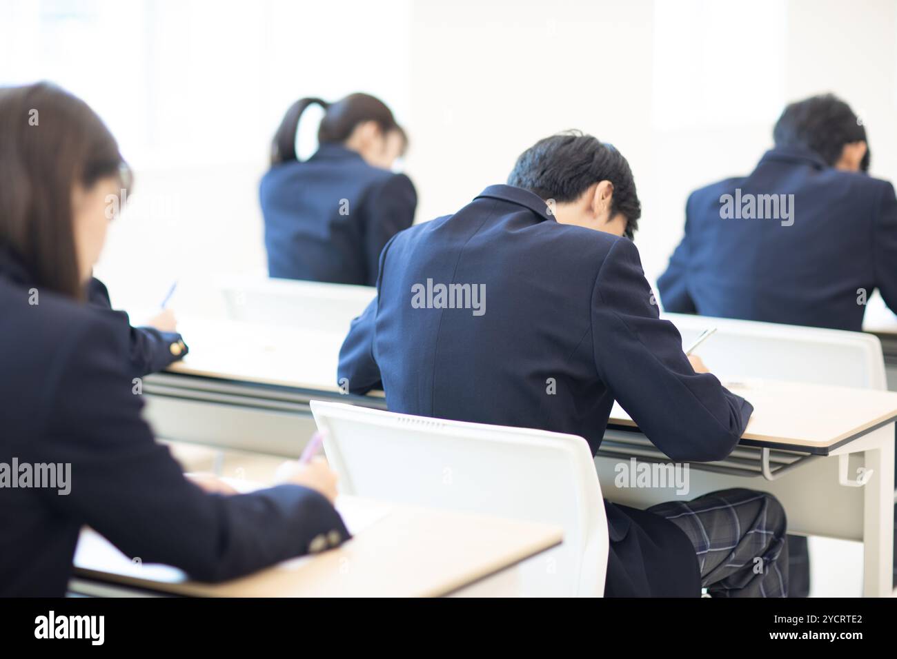 Rear view of students taking a class in a classroom Stock Photo - Alamy