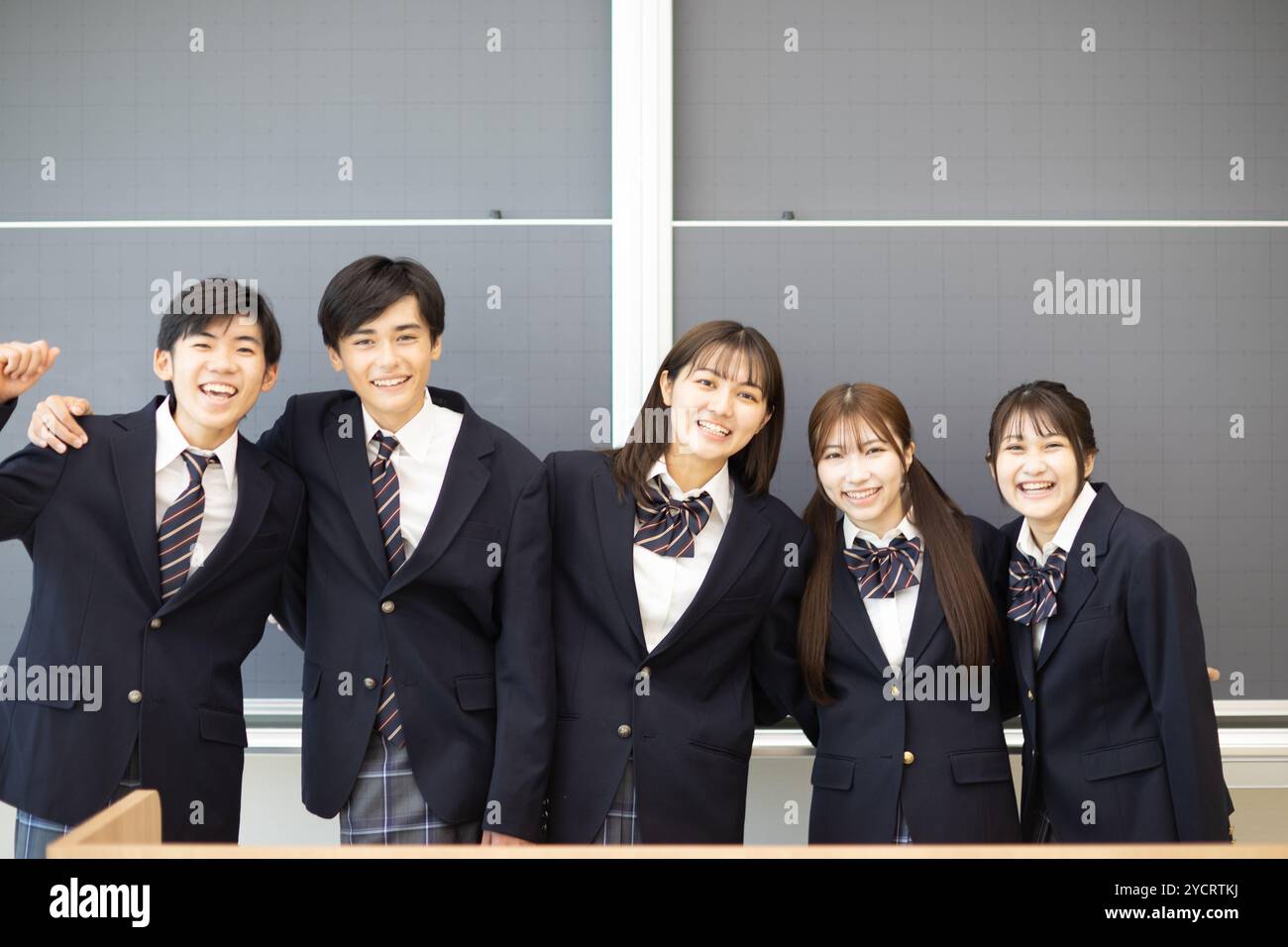 Students laughing in front of the blackboard Stock Photo - Alamy