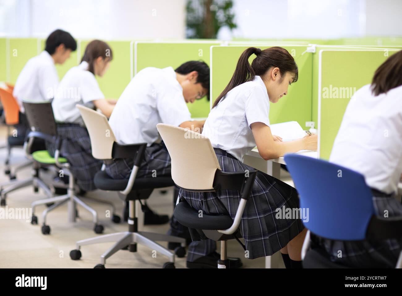 Rear view of students studying in a classroom Stock Photo - Alamy