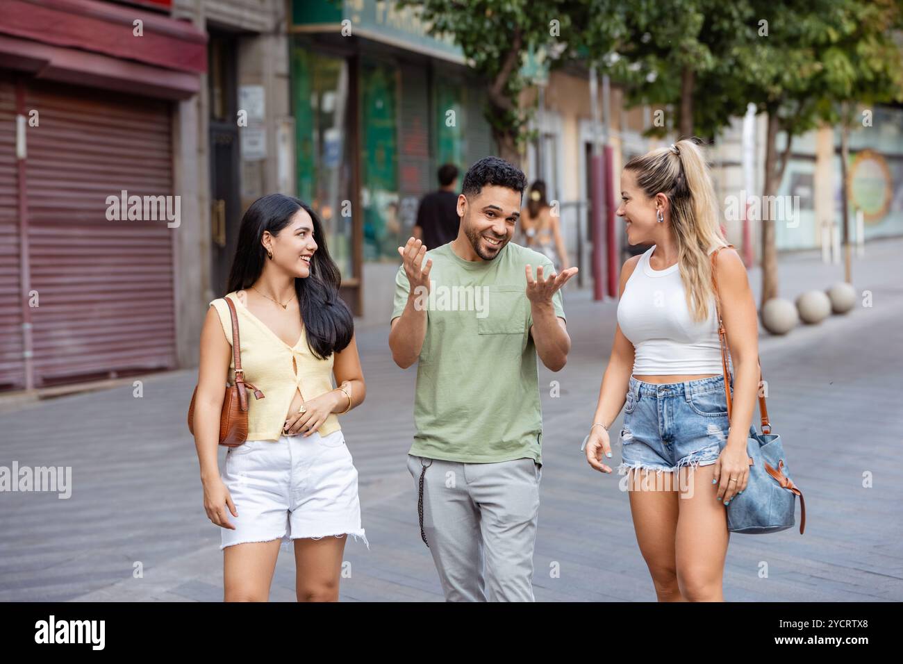 Three young friends stroll down hi-res stock photography and images - Alamy