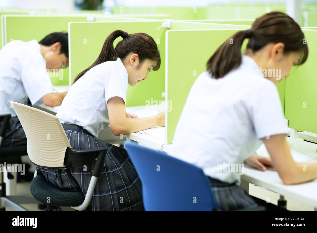 Rear view of students studying in a classroom Stock Photo - Alamy