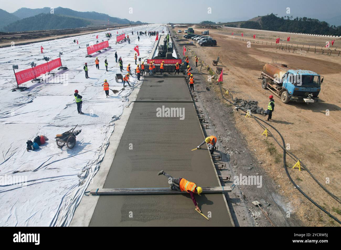 LISHUI, CHINA - OCTOBER 24, 2024 - Construction workers pave the runway ...