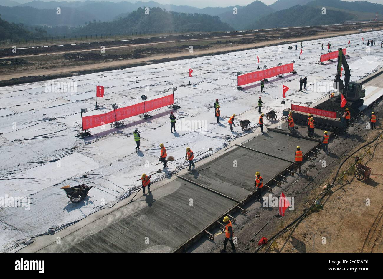 LISHUI, CHINA - OCTOBER 24, 2024 - Construction workers pave the runway ...