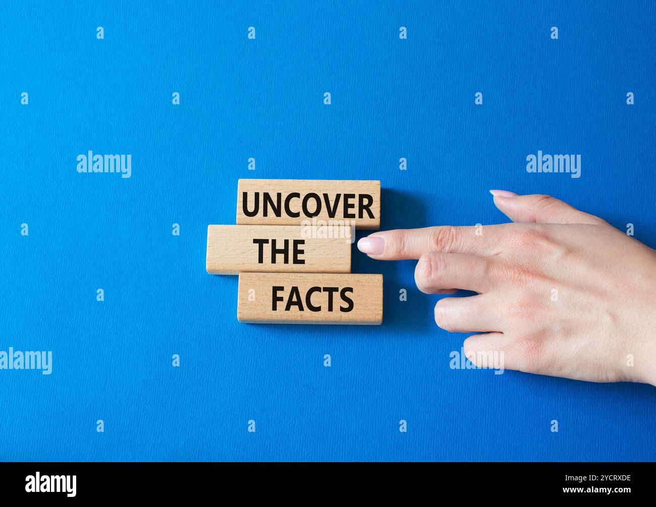 Uncover the Facts symbol. Concept word Uncover the Facts on wooden ...