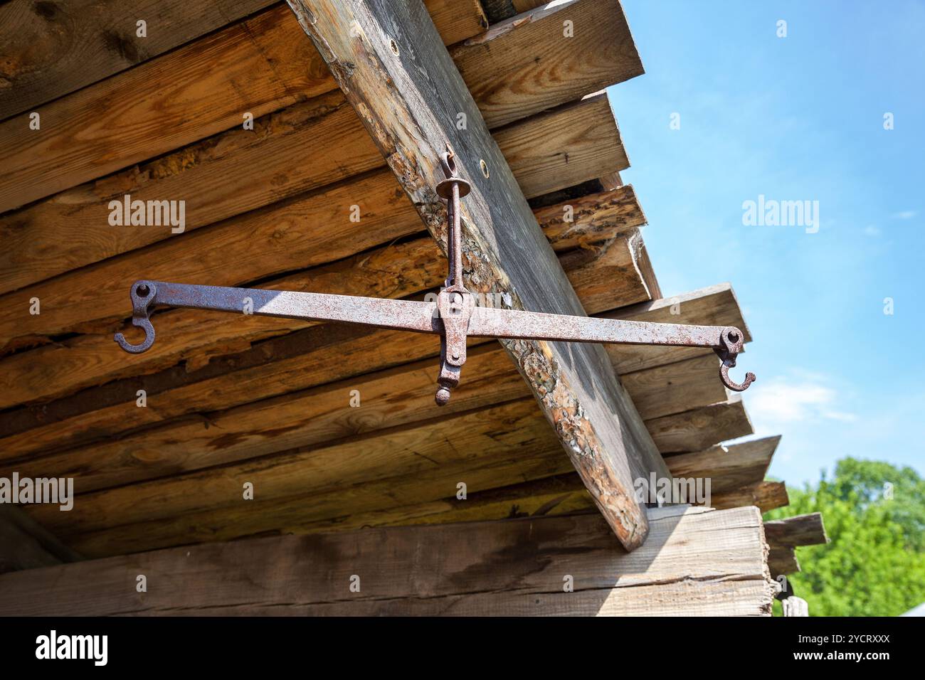 Old rusty empty metal scale suspended on the wooden wall Stock Photo ...