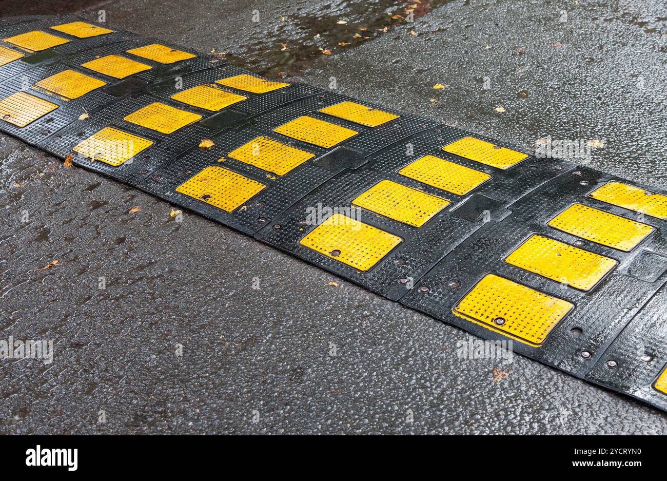 Traffic safety speed bump on an asphalt road Stock Photo - Alamy