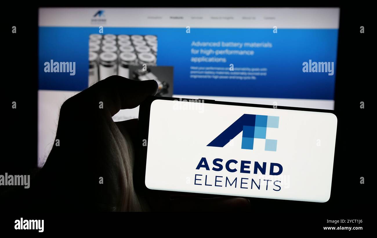 Person holding mobile phone with logo of battery materials company Ascend Elements Inc. on ...