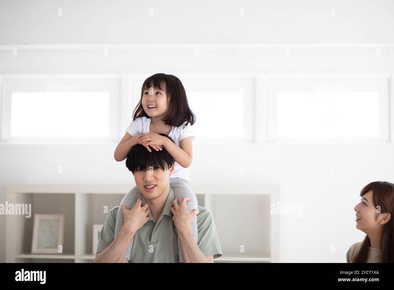 Parent and child playing with a shoulder cart Stock Photo - Alamy