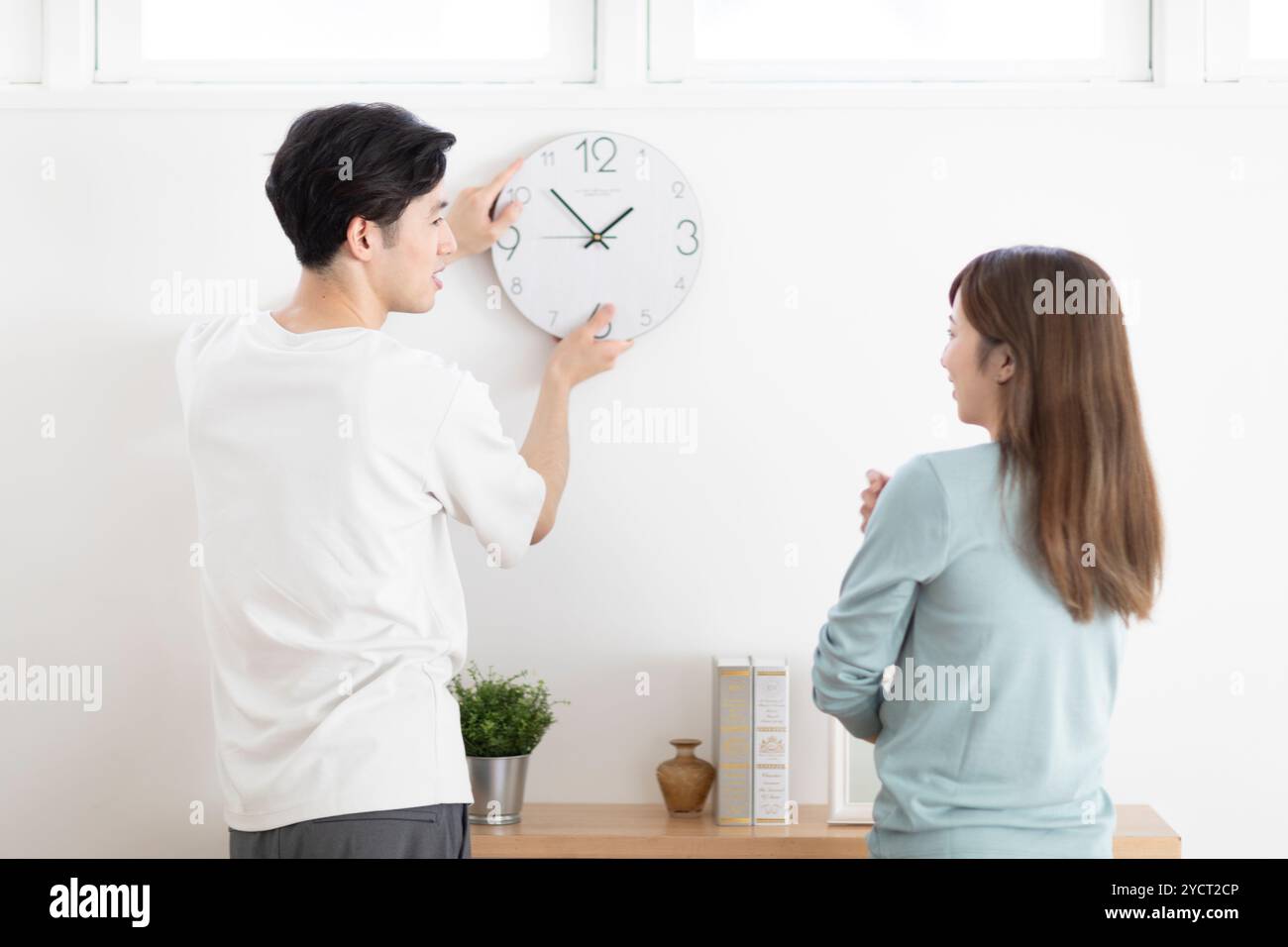 Man hanging on clock hi-res stock photography and images - Alamy