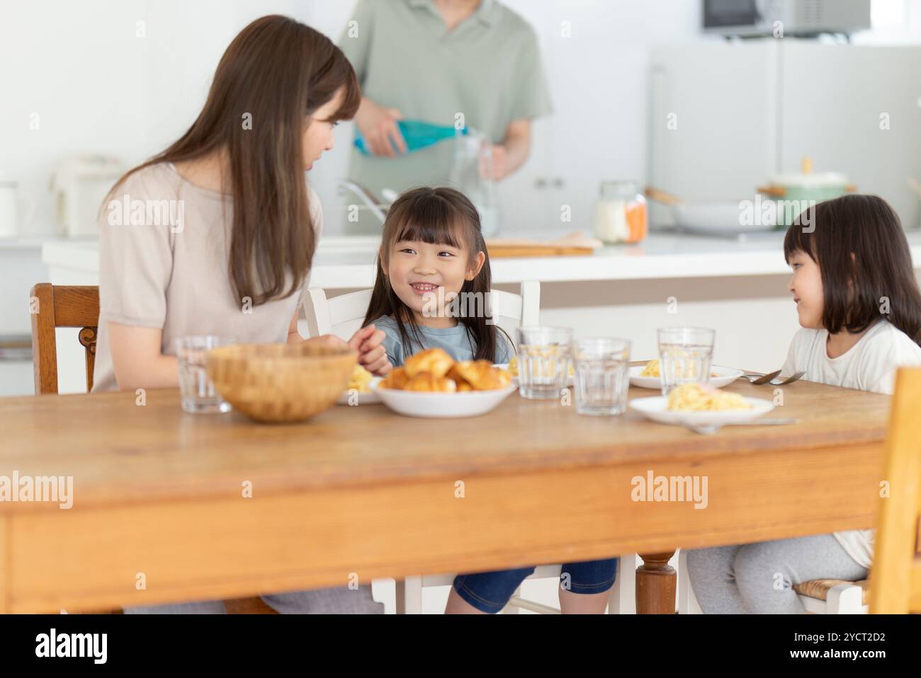 Family around the dining table Stock Photo - Alamy