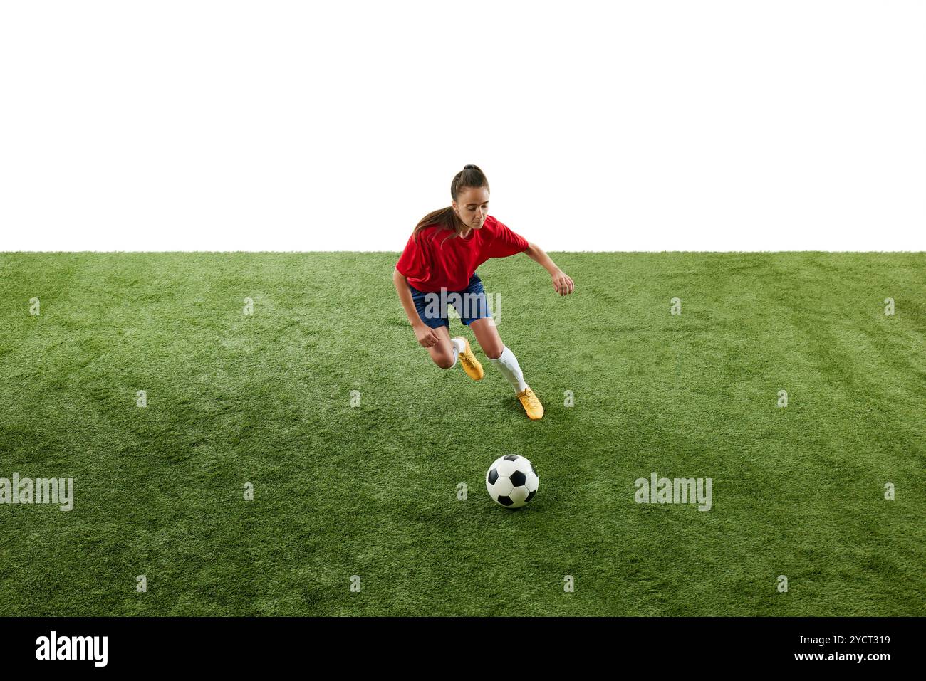 Competitive young woman, soccer player running across football field ...