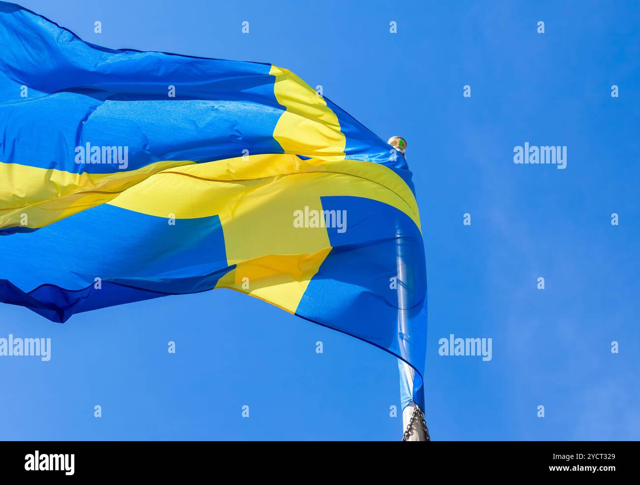 Flag of Sweden waving in the wind on a blue sky background Stock Photo ...