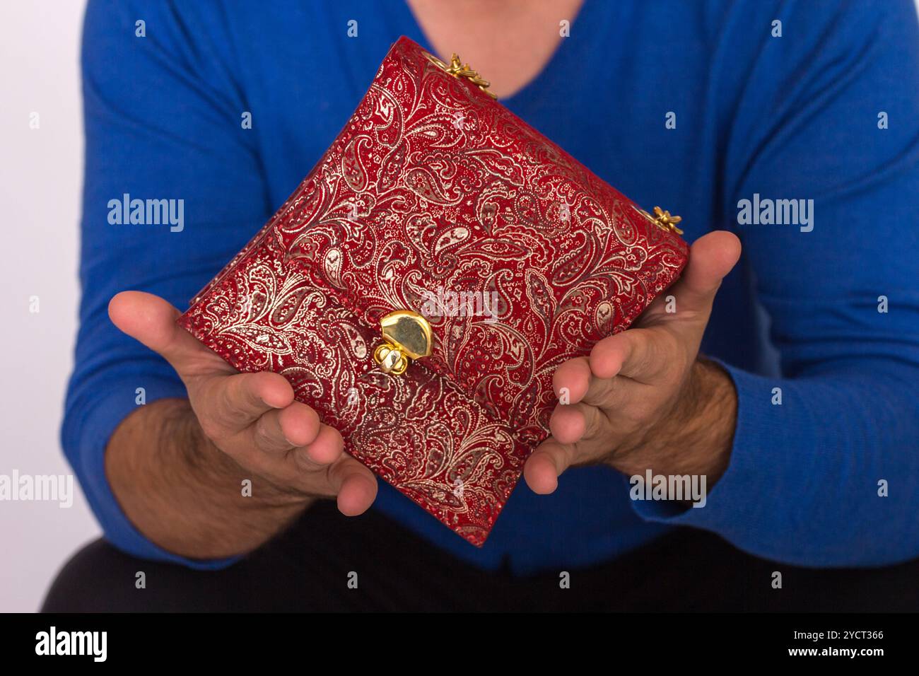 Strong male hands holding handbags Stock Photo - Alamy
