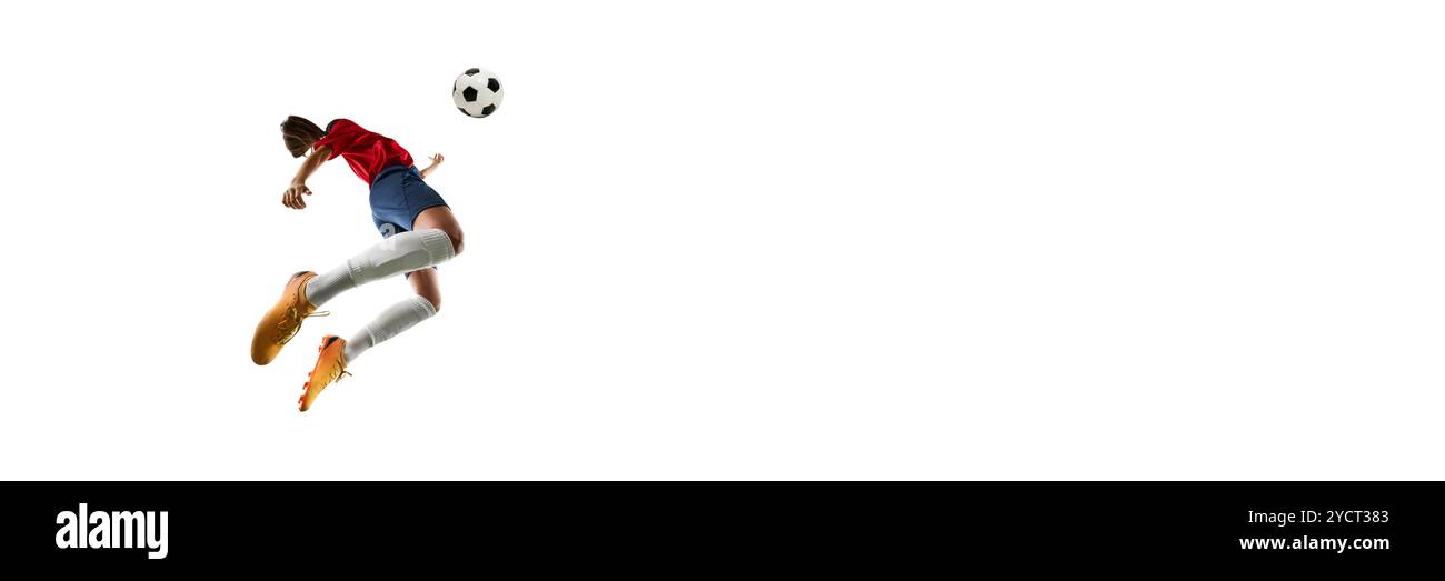 Banner. Female athlete, soccer player jumping in mid-air to hit ball ...