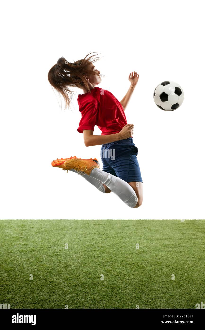 Female athlete, soccer player jumping in mid-air to hit ball with chest ...
