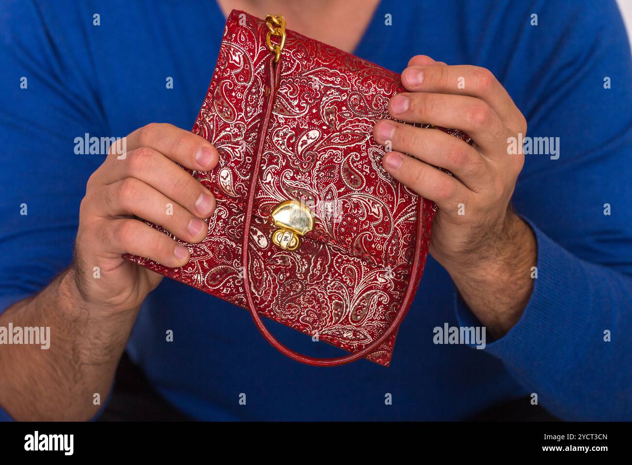 Strong male hands holding handbags Stock Photo - Alamy