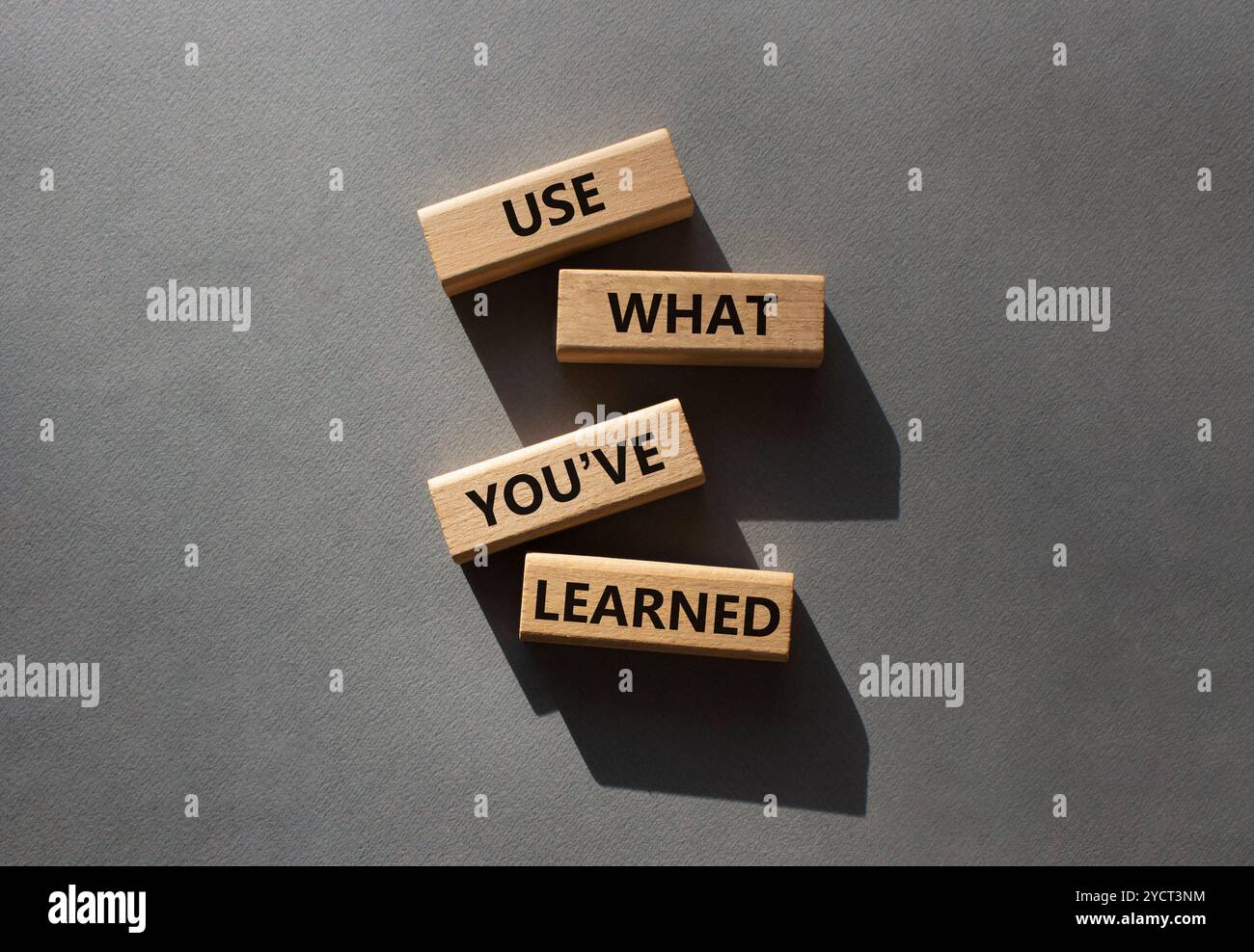 Use what You have learned symbol. Wooden blocks with words Use what You ...