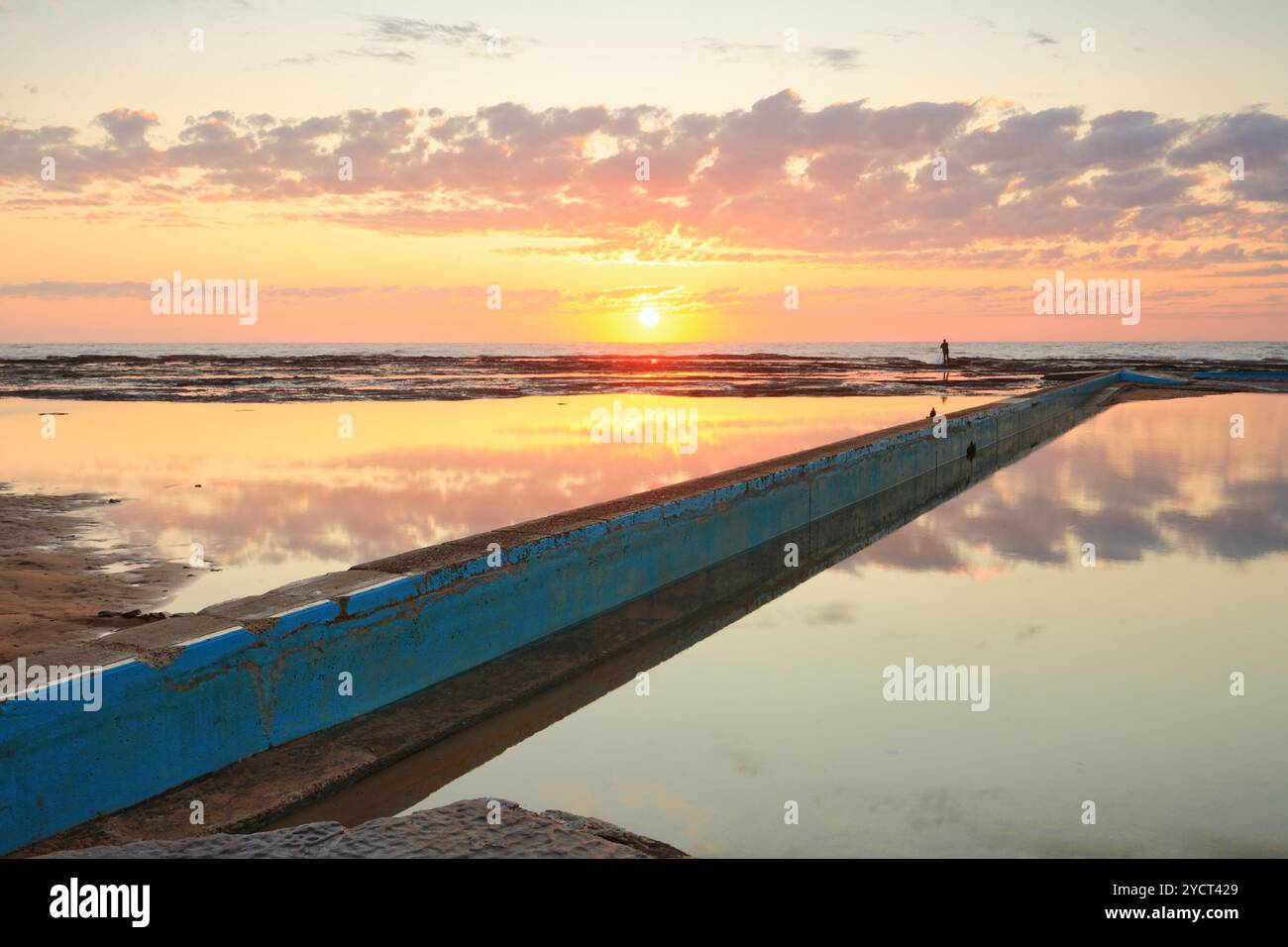 Views across Narrabeen rock pool and rock shelf just after sunrise ...