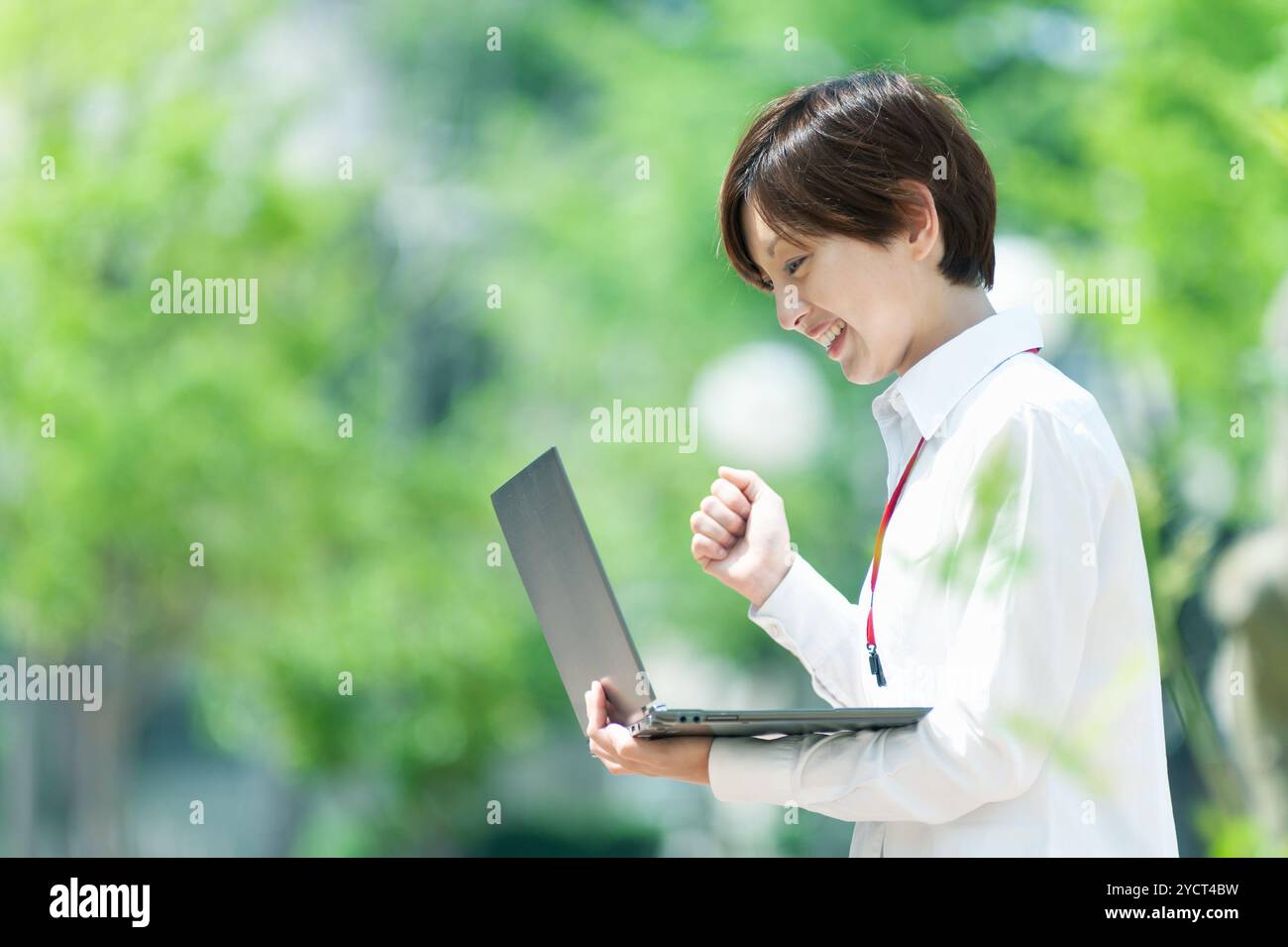 Woman operating laptop outdoors hi-res stock photography and images - Alamy