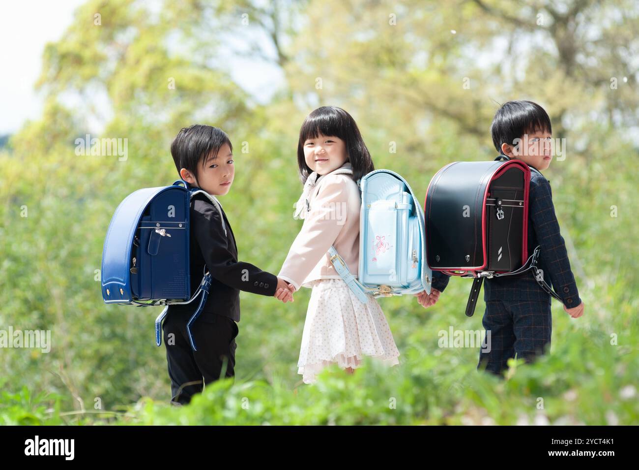 Three new first-year students looking back in a row Stock Photo - Alamy