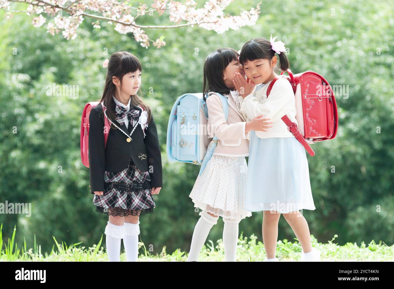 Three new first-year students in formal dress talking in private Stock ...