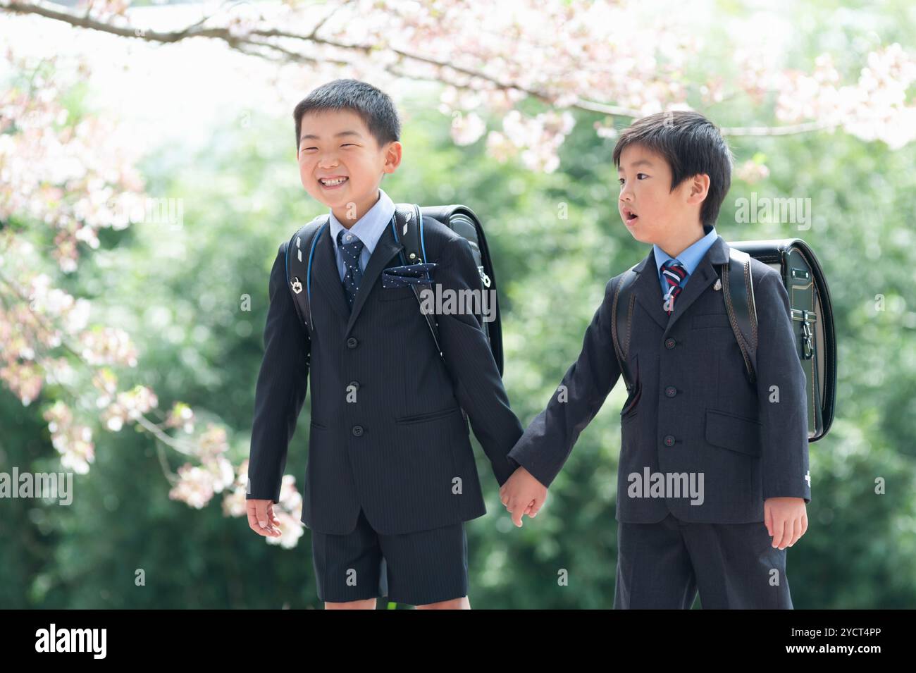 Two first-year boys in formal wear walking hand in hand Stock Photo - Alamy