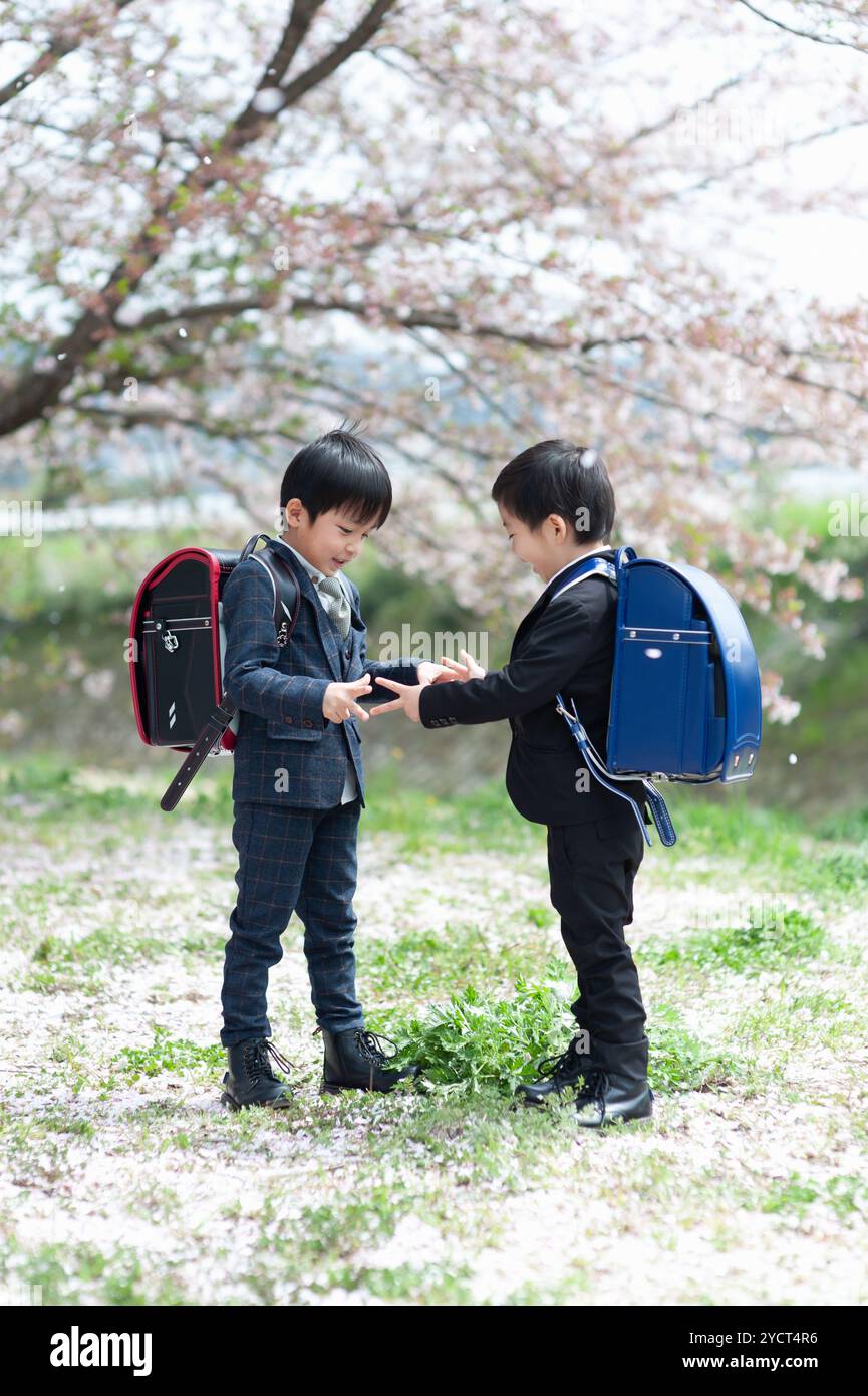 New first-year boy playing hand games in formal dress Stock Photo - Alamy