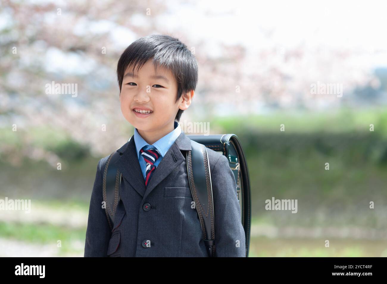 New first-year boy smiling in formal dress Stock Photo - Alamy