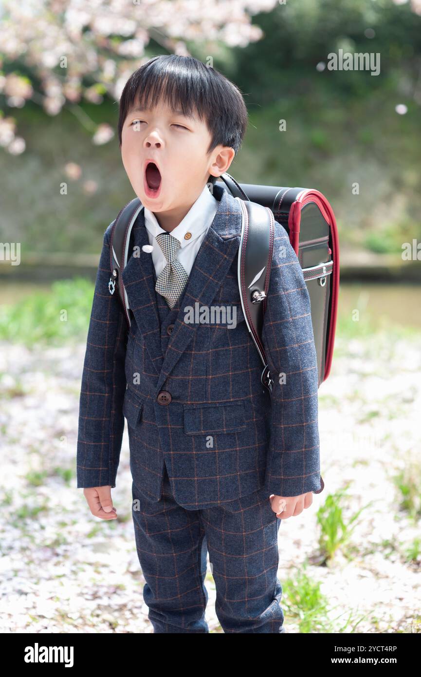 New first-year boy in formal dress yawning Stock Photo - Alamy