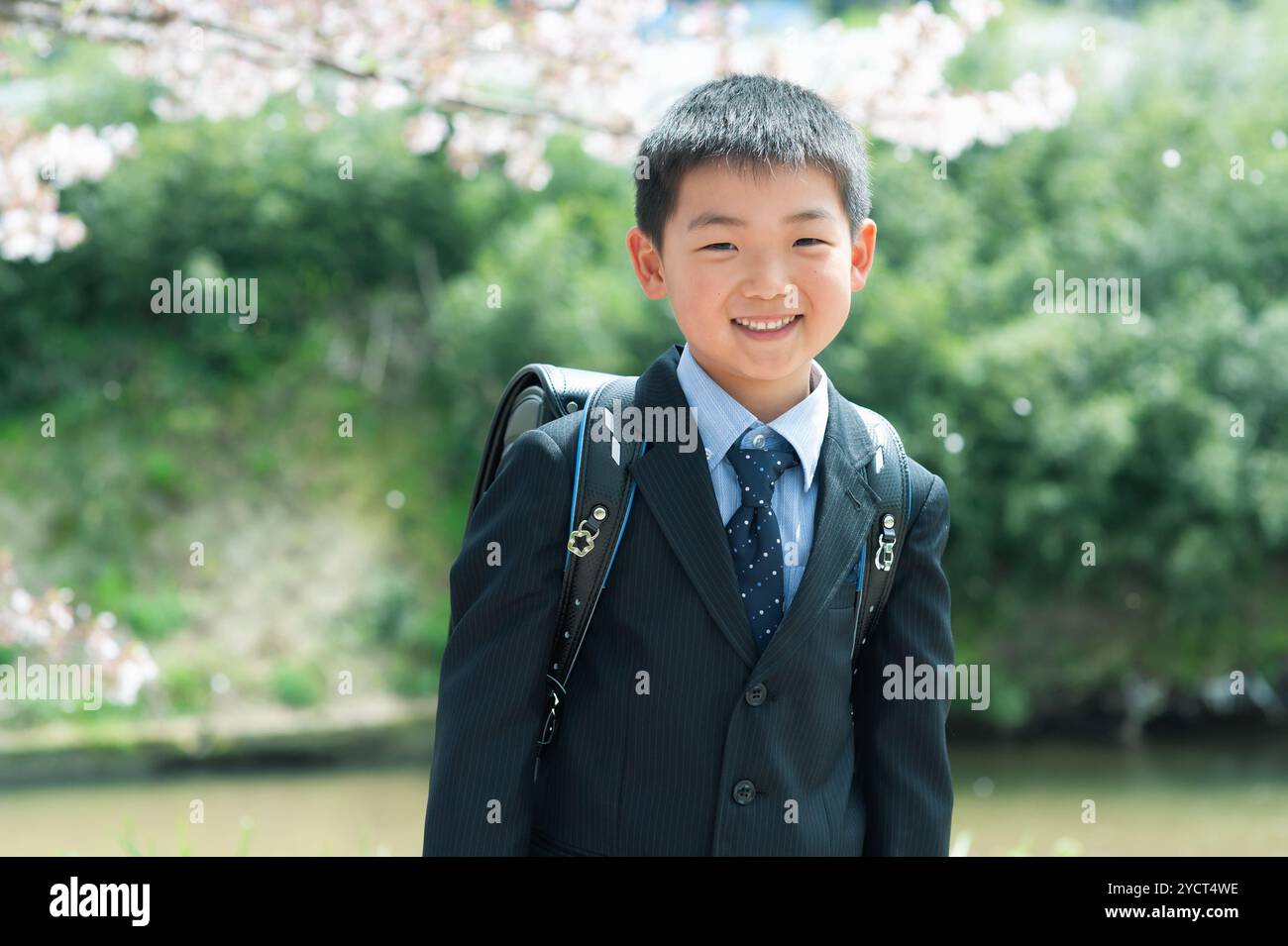 New first-year boy smiling in formal dress Stock Photo - Alamy