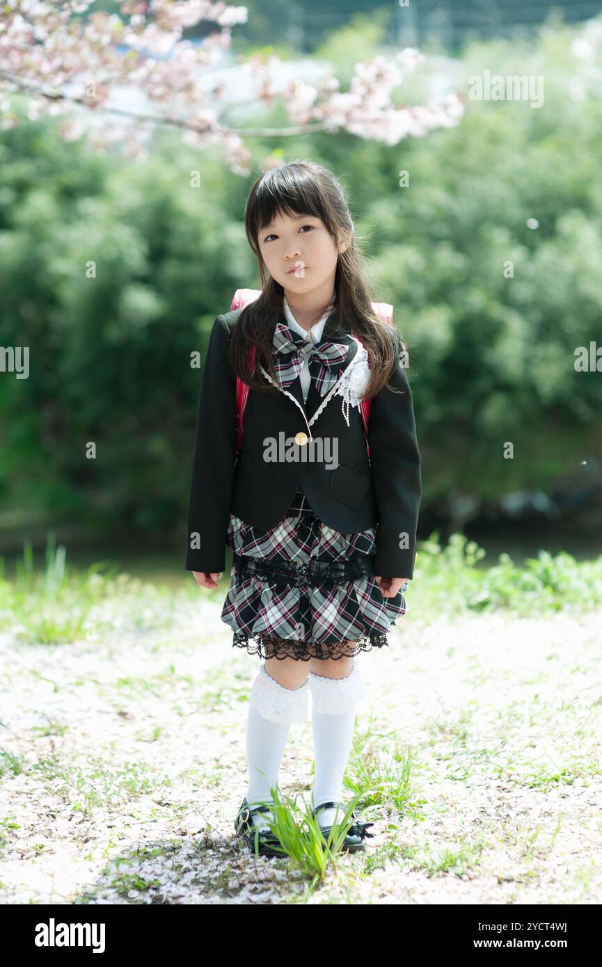 New first year girl smiling in formal dress Stock Photo - Alamy